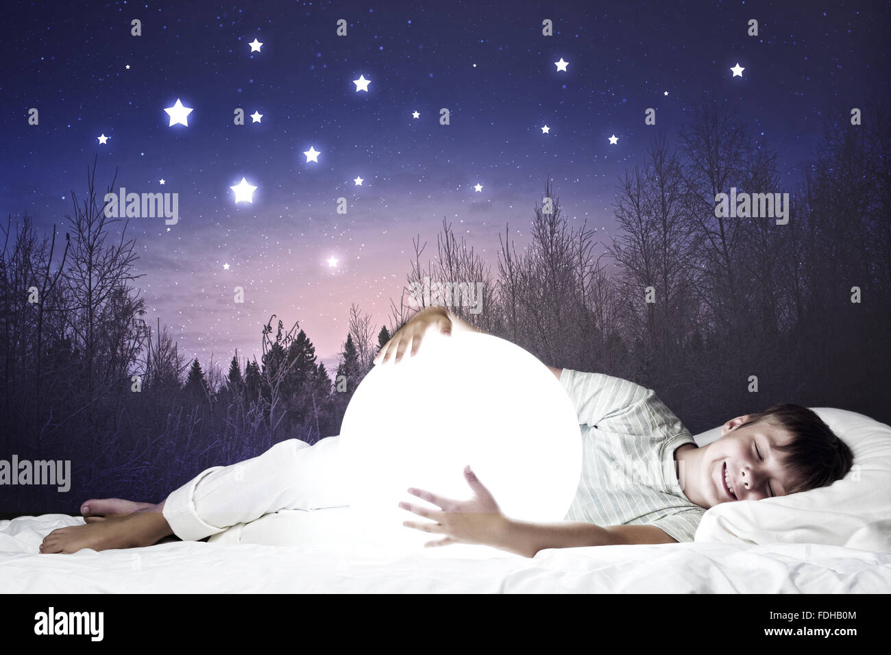 Cute boy sleeping in bed with moon Stock Photo - Alamy