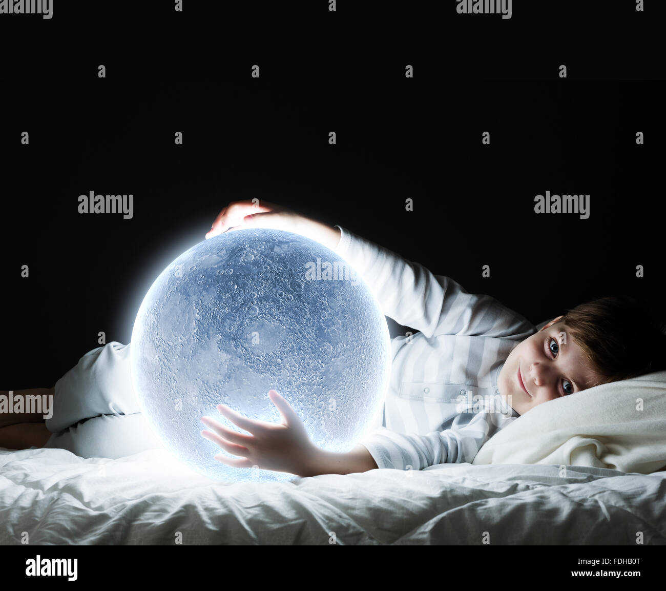 Cute boy sleeping in bed with moon Stock Photo - Alamy