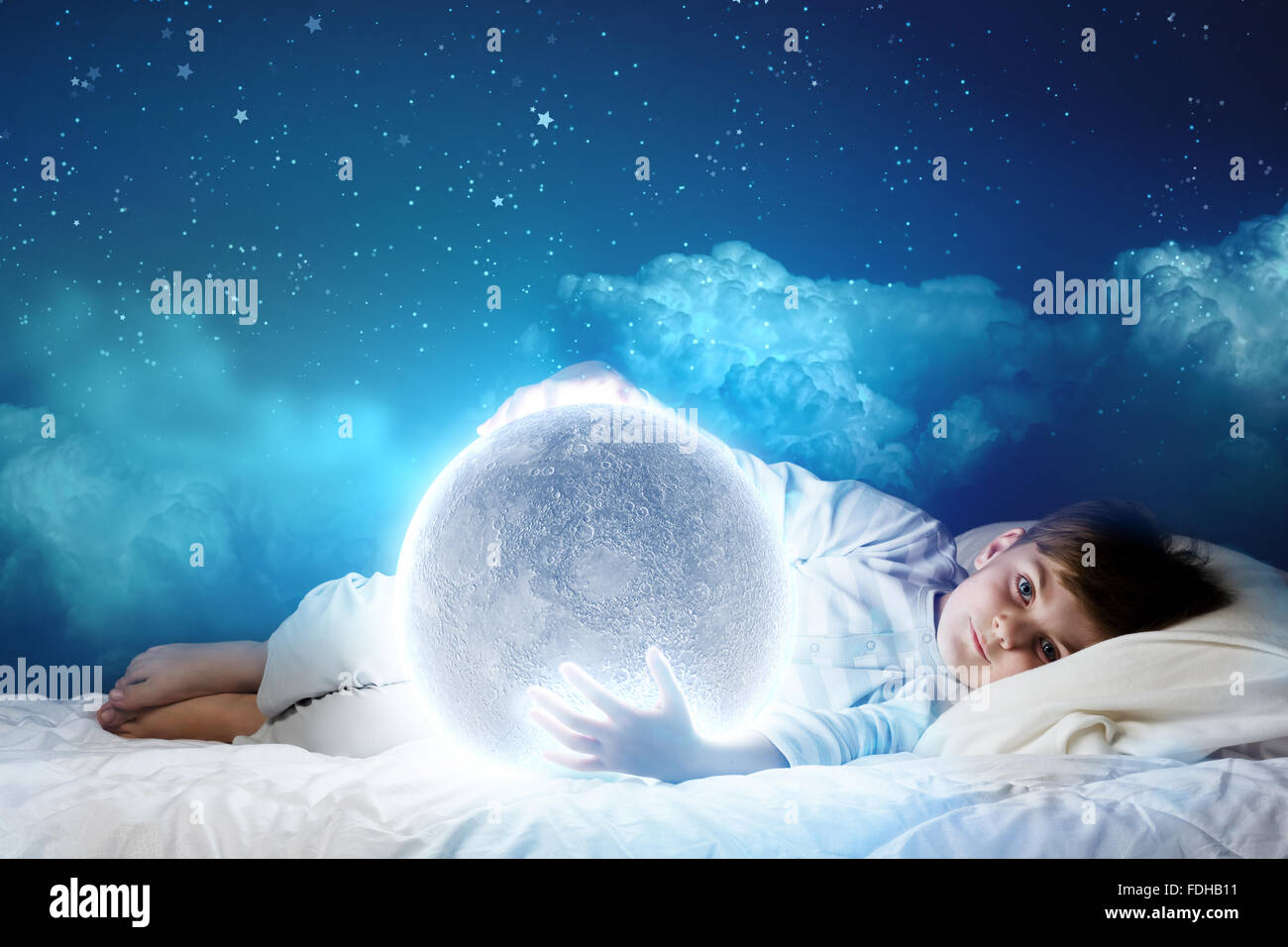 Cute boy sleeping in bed with moon Stock Photo - Alamy