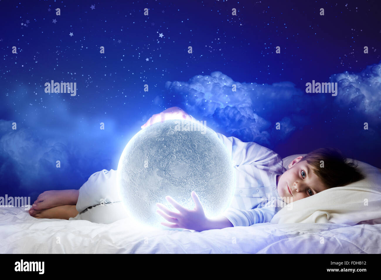 Cute boy sleeping in bed with moon Stock Photo - Alamy