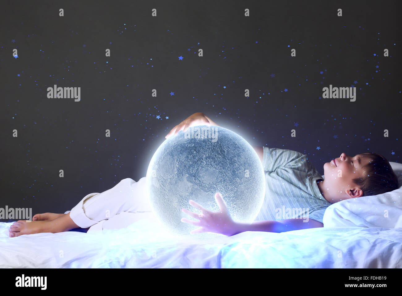 Cute boy sleeping in bed with moon Stock Photo - Alamy