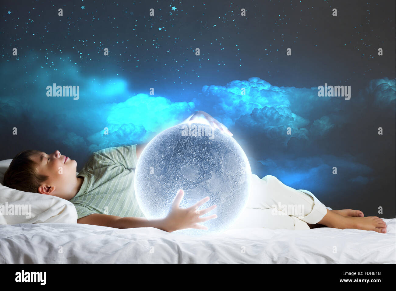 Cute boy sleeping in bed with moon Stock Photo - Alamy