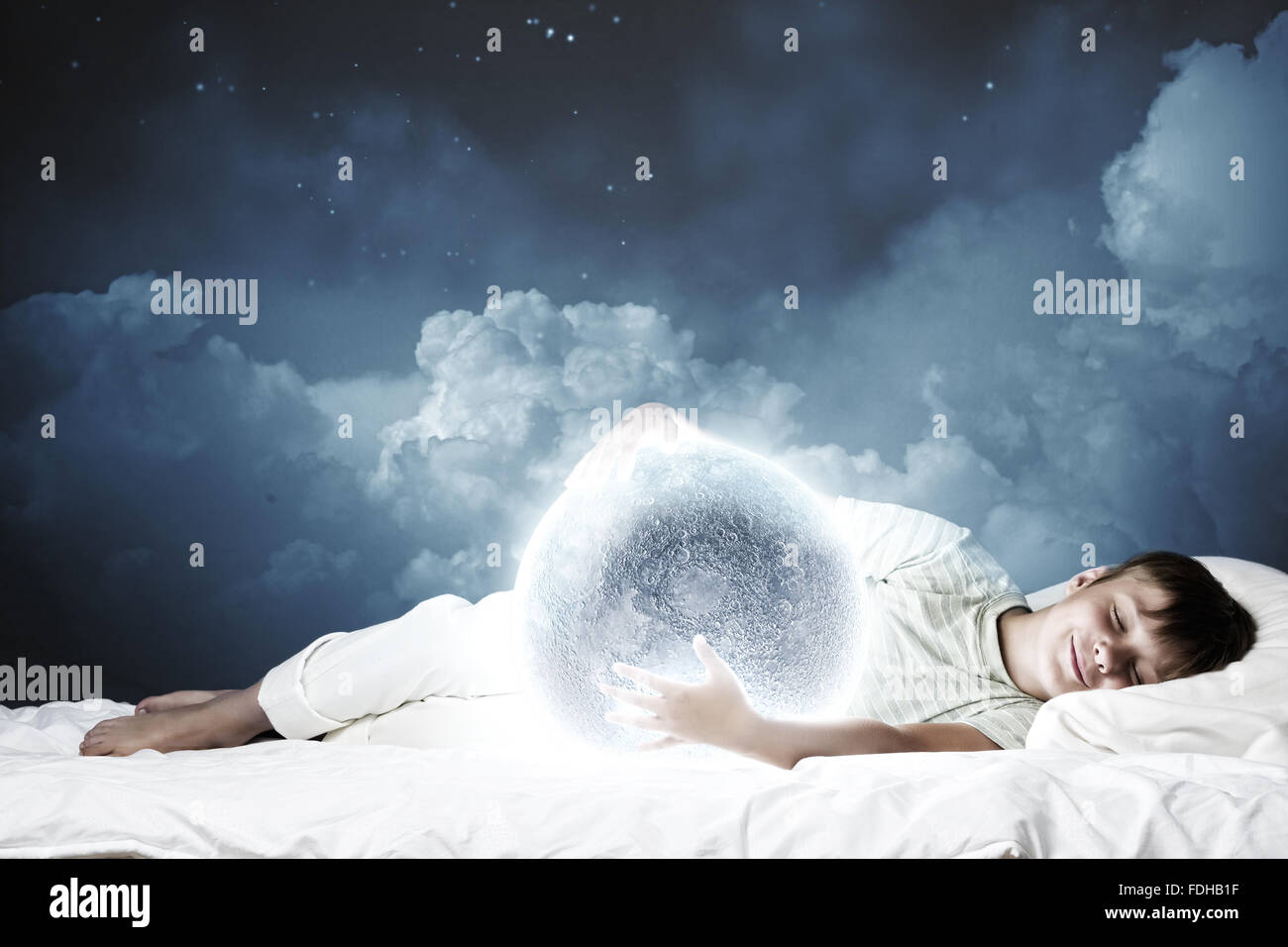 Cute boy sleeping in bed with moon Stock Photo - Alamy