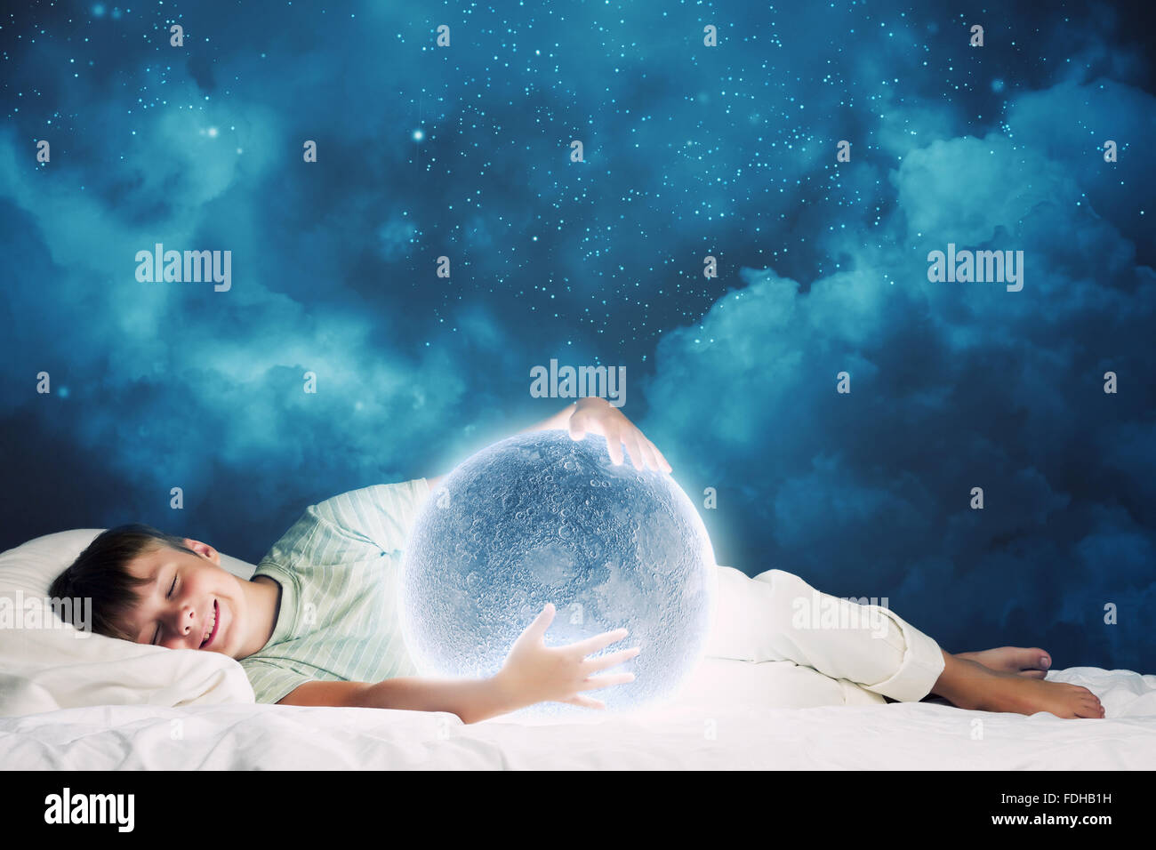 Cute boy sleeping in bed with moon Stock Photo - Alamy