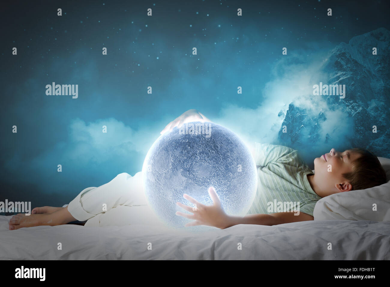 Cute boy sleeping in bed with moon Stock Photo - Alamy