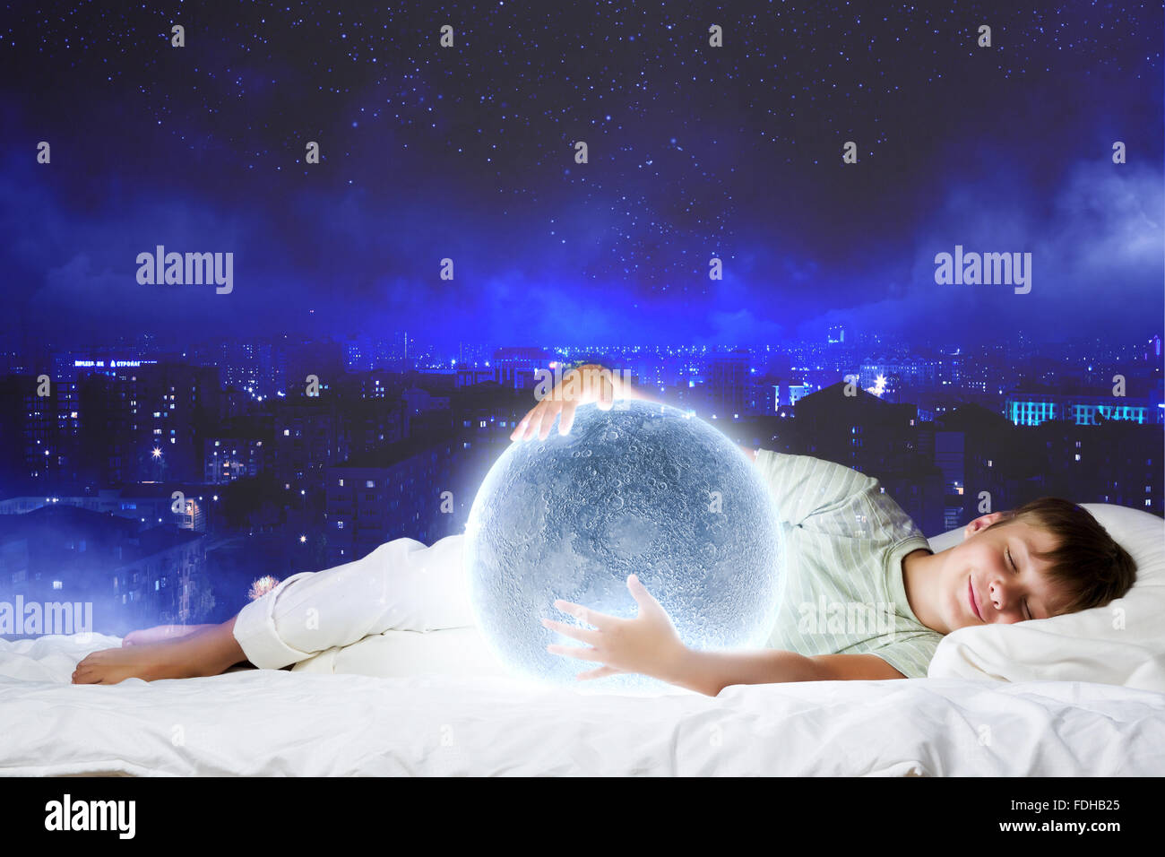 Cute boy sleeping in bed with moon Stock Photo - Alamy