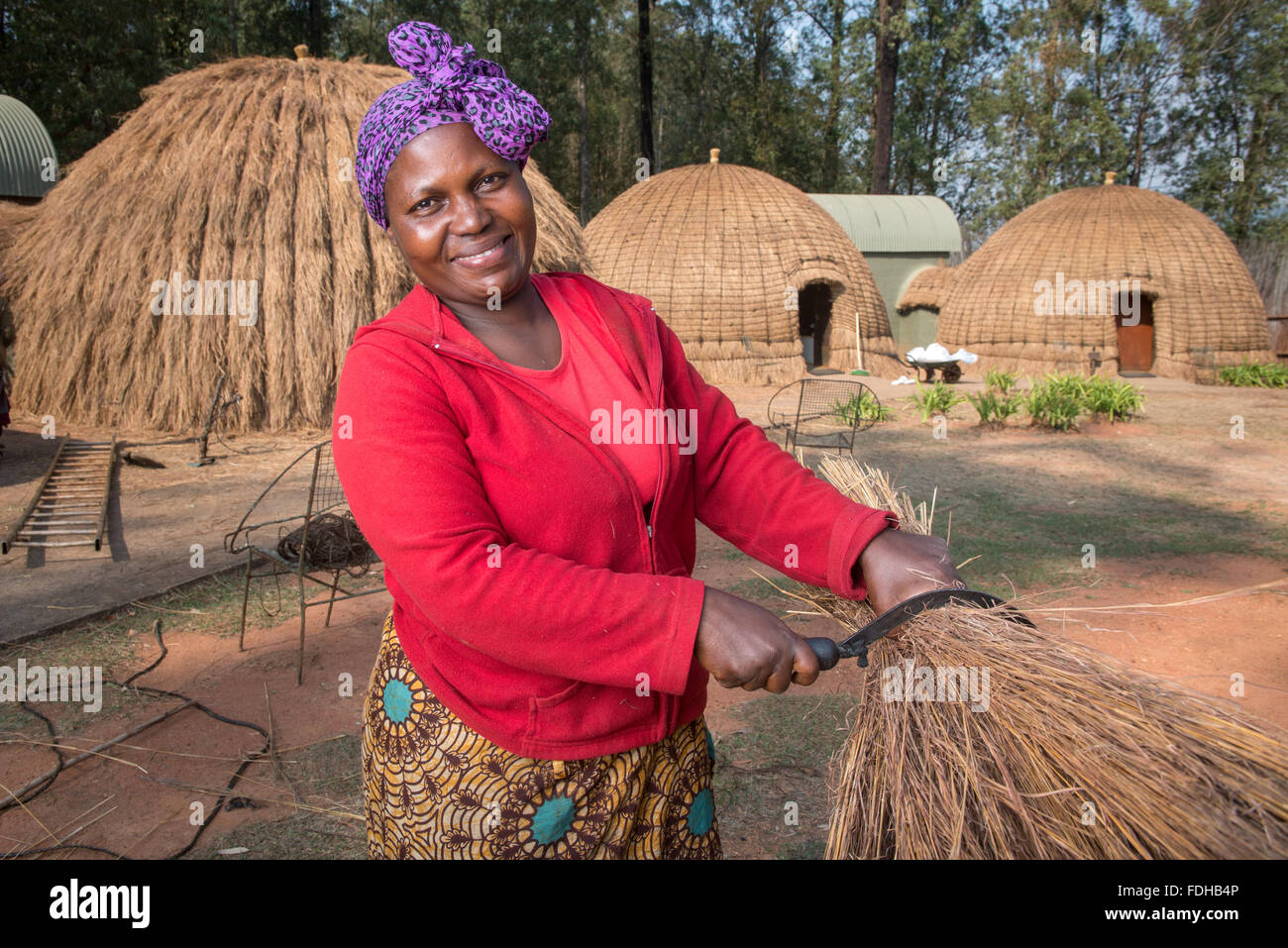 Portrait of a woman making a beehive hut at the Mlilwane Wildlife ...