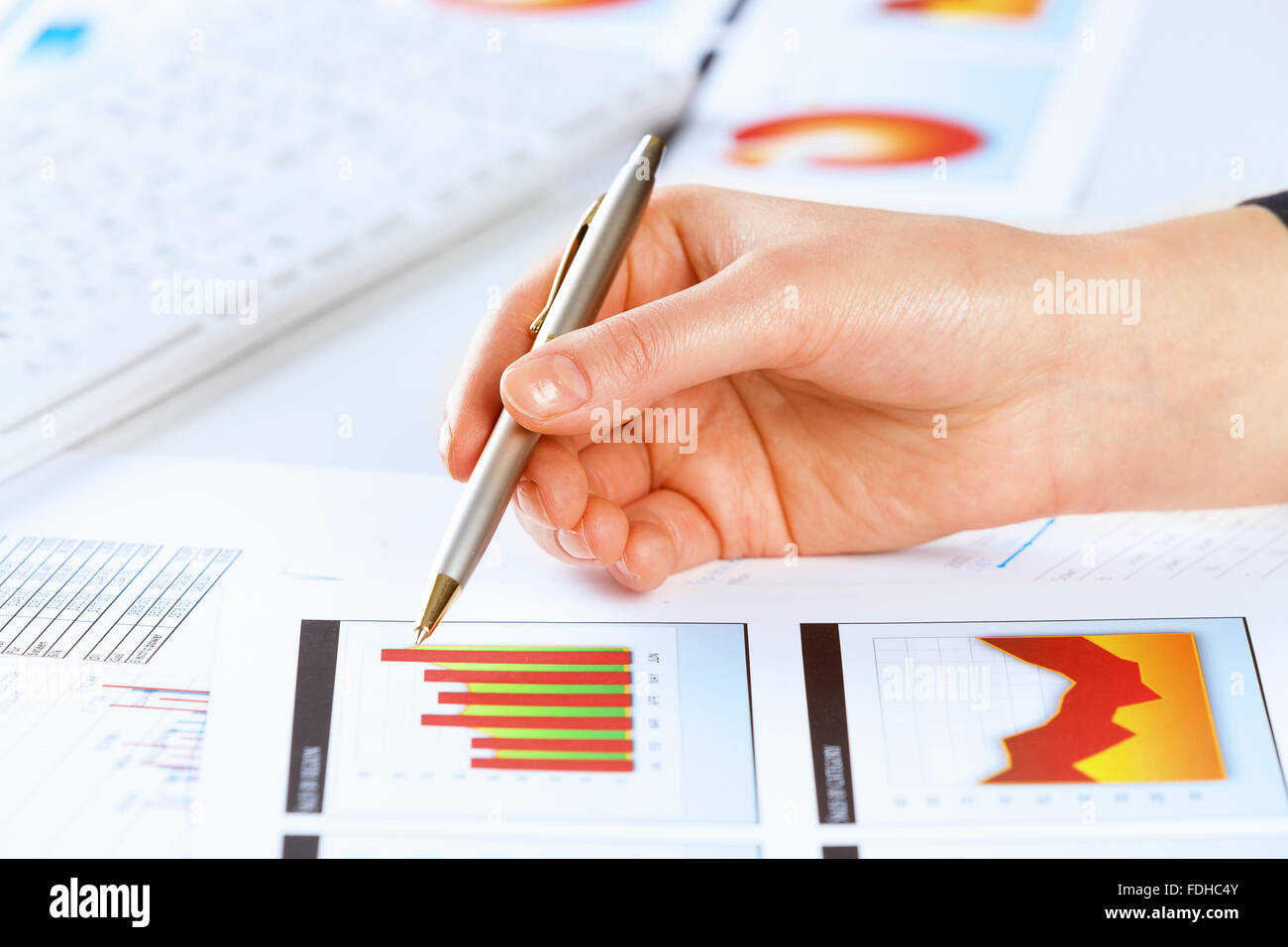 Close up of male hand holding pen and pointing at graphs Stock Photo ...