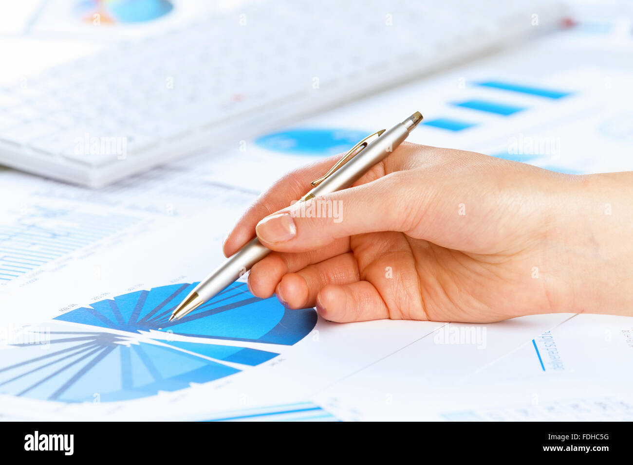 Close up of male hand holding pen and pointing at graphs Stock Photo ...