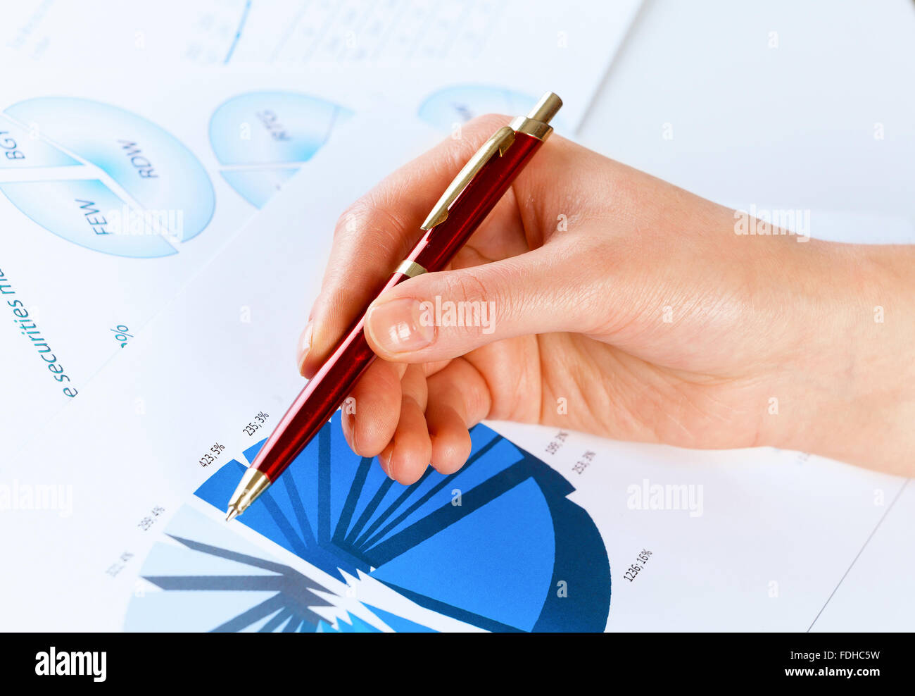 Close up of male hand holding pen and pointing at graphs Stock Photo ...