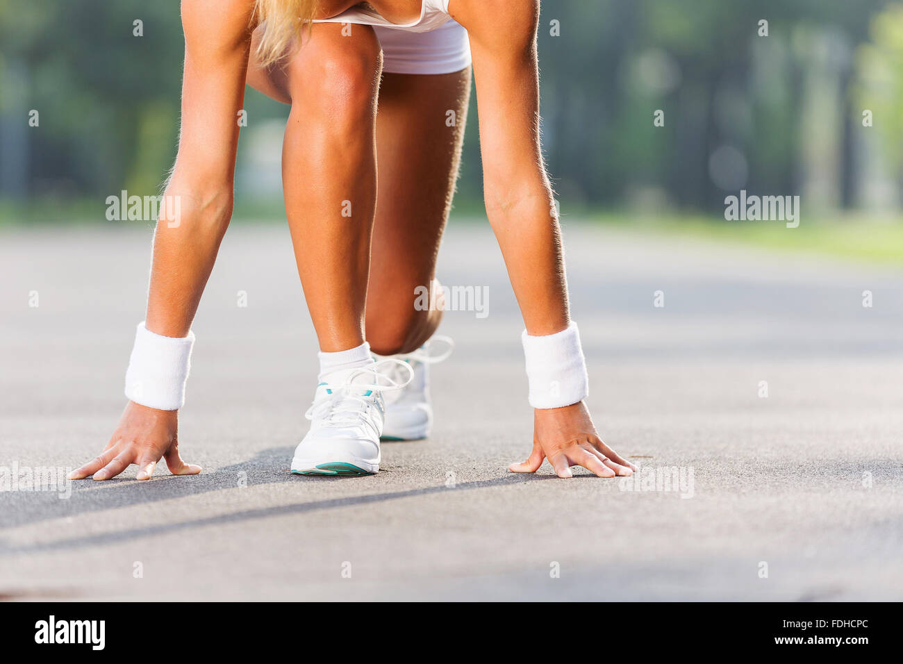 Bottom view of young sport woman in start pose Stock Photo - Alamy