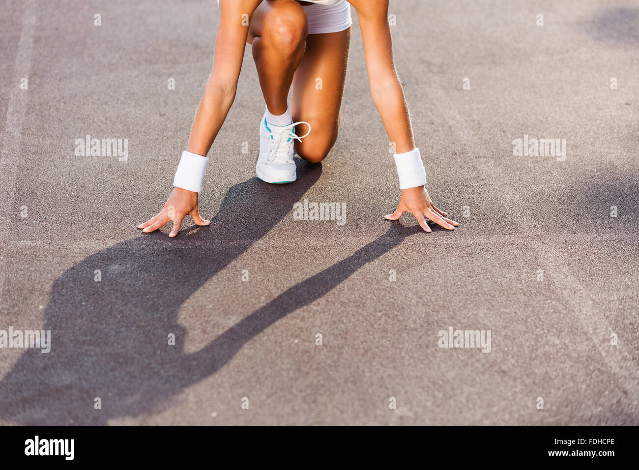 Bottom view of young sport woman in start pose Stock Photo - Alamy