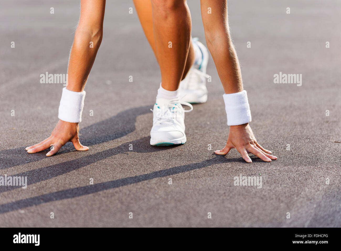Bottom view of young sport woman in start pose Stock Photo - Alamy