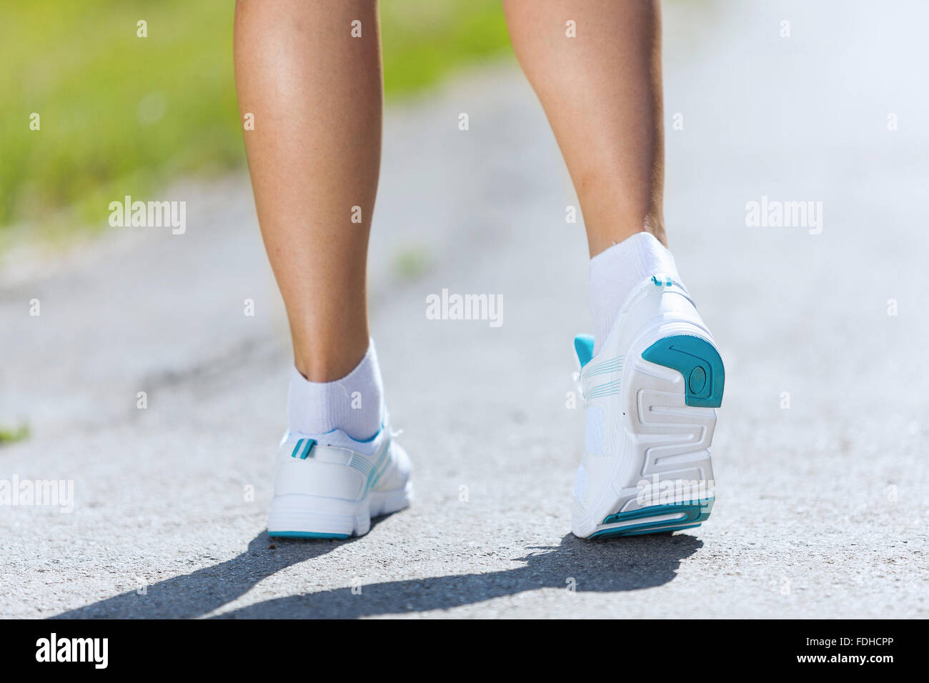 Woman running on road legs hi-res stock photography and images - Alamy
