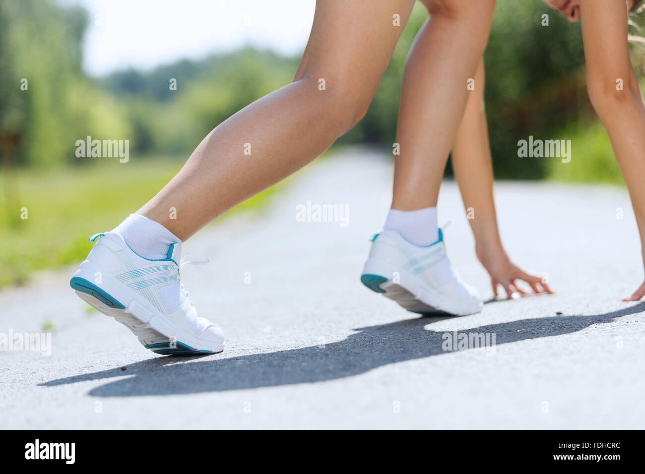 Bottom view of young sport woman in start pose Stock Photo - Alamy