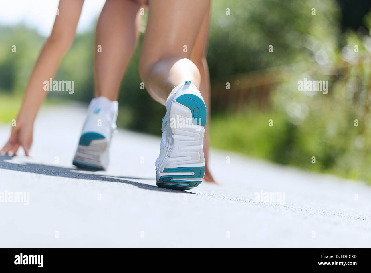 Bottom view of young sport woman in start pose Stock Photo - Alamy