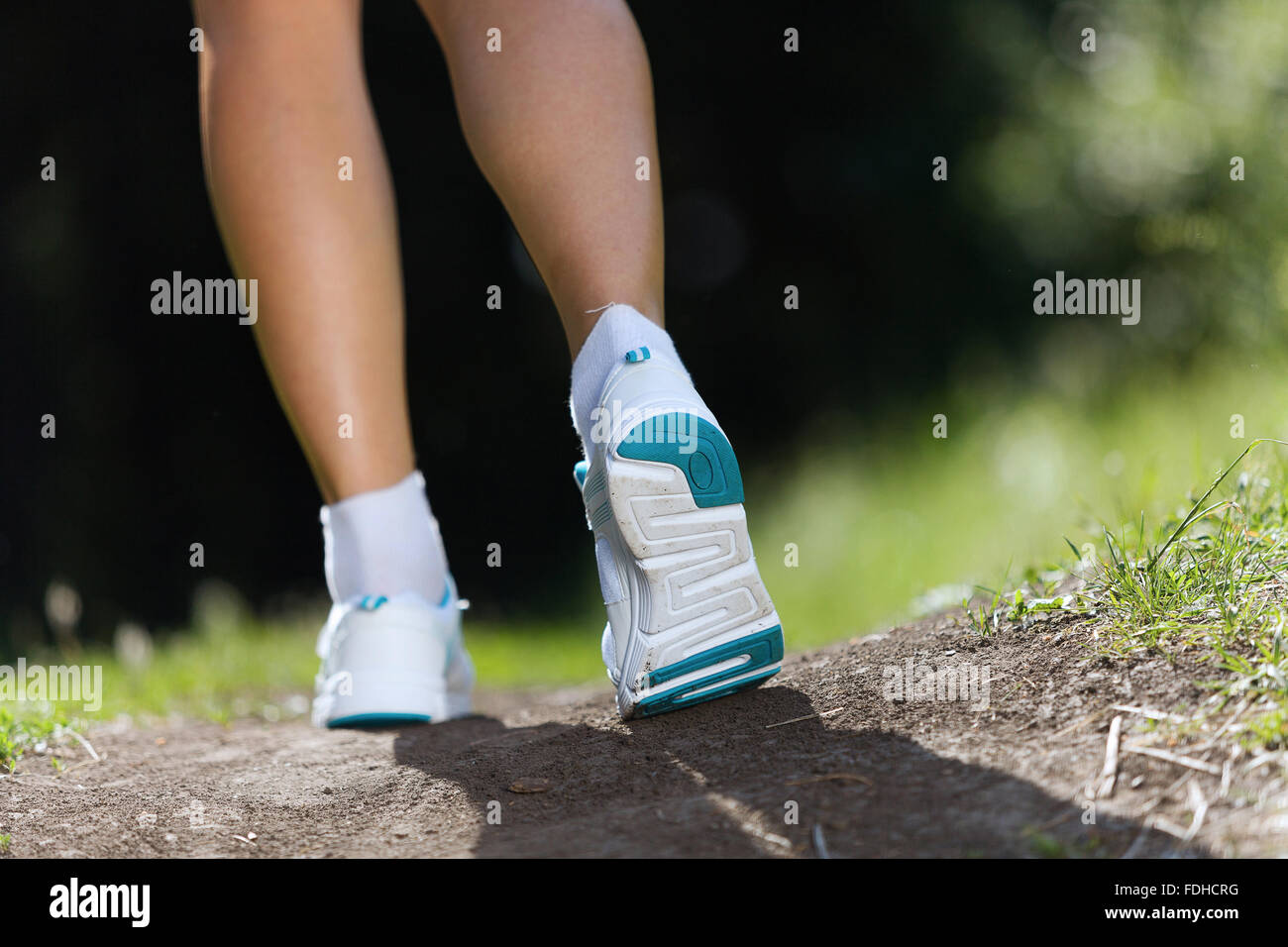 Close up of female feet running on road Stock Photo - Alamy