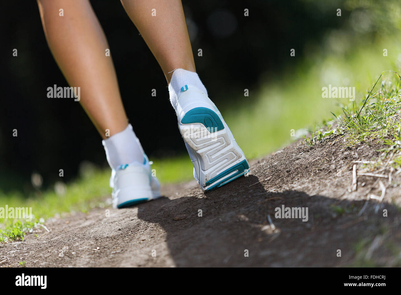 Close up of female feet running on road Stock Photo - Alamy