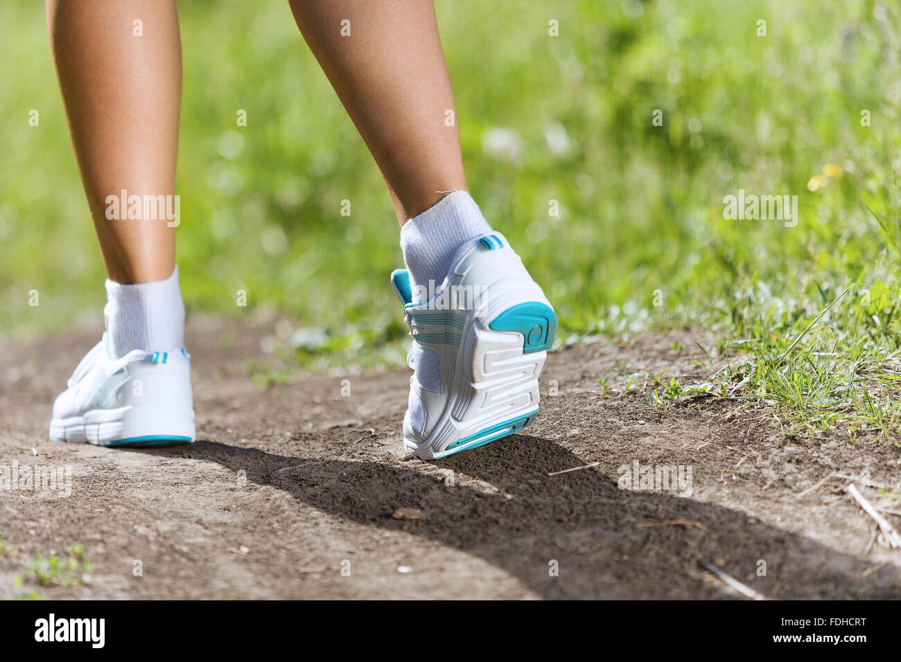 Close up of female feet running on road Stock Photo - Alamy