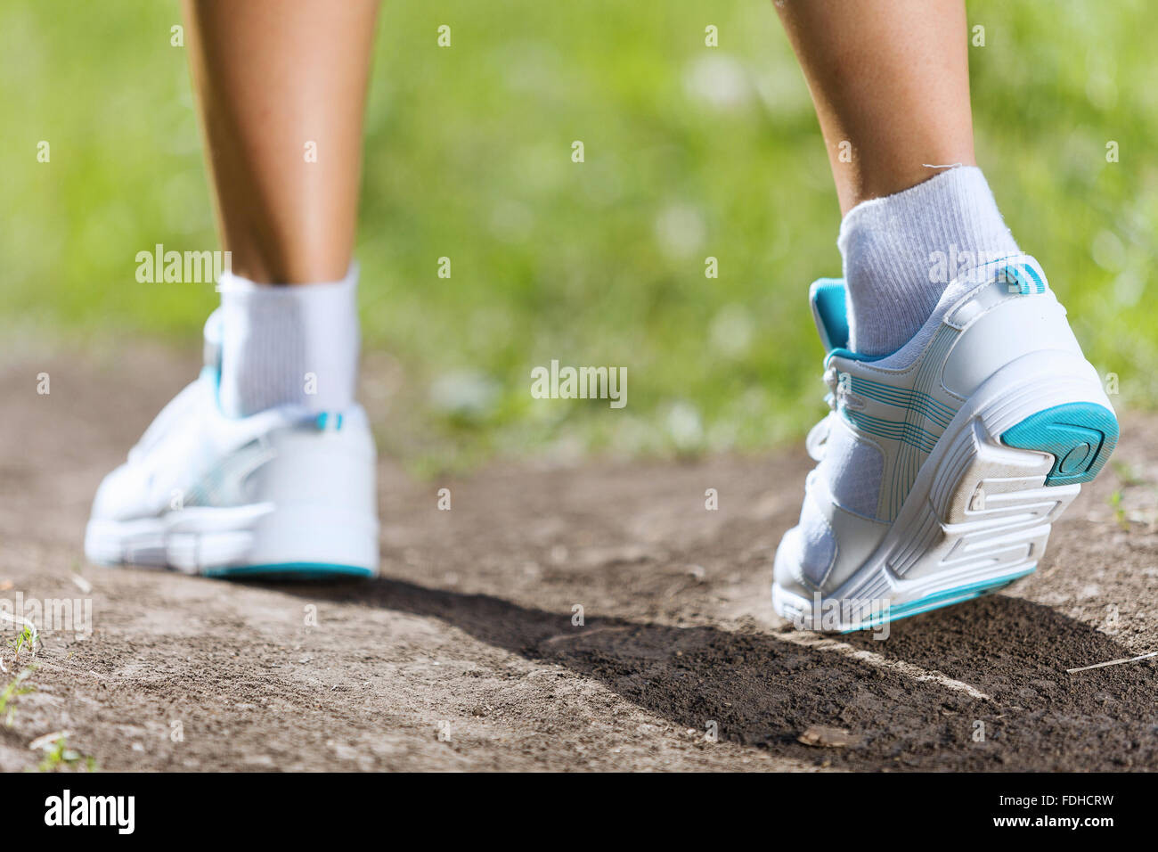 Close up of female feet running on road Stock Photo - Alamy