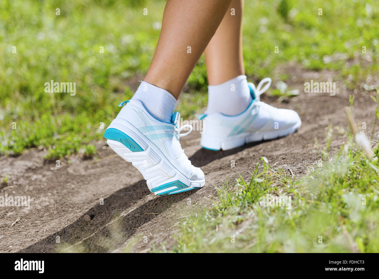 Close up of female feet running on road Stock Photo - Alamy