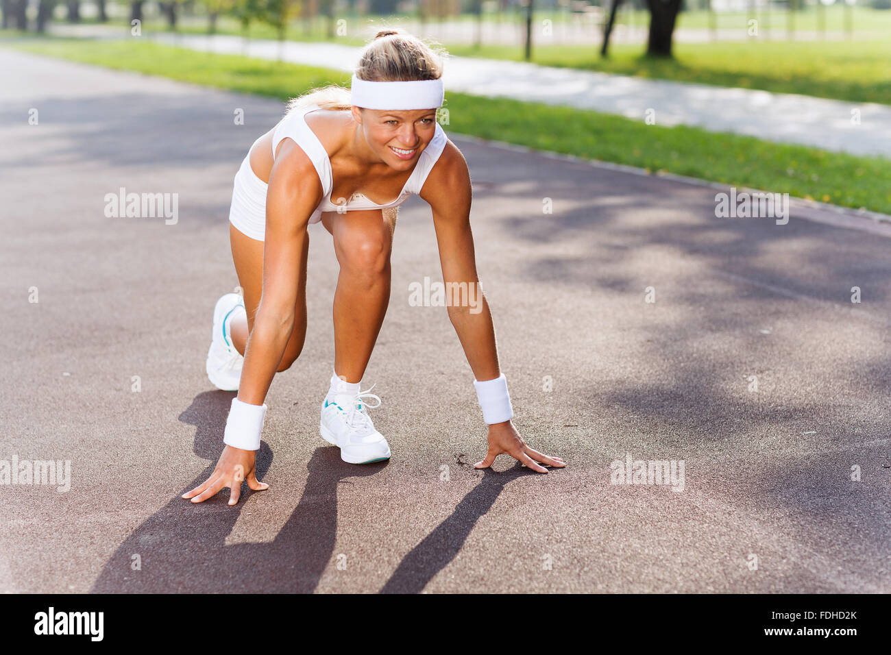 Bottom view of young sport woman in start pose Stock Photo - Alamy