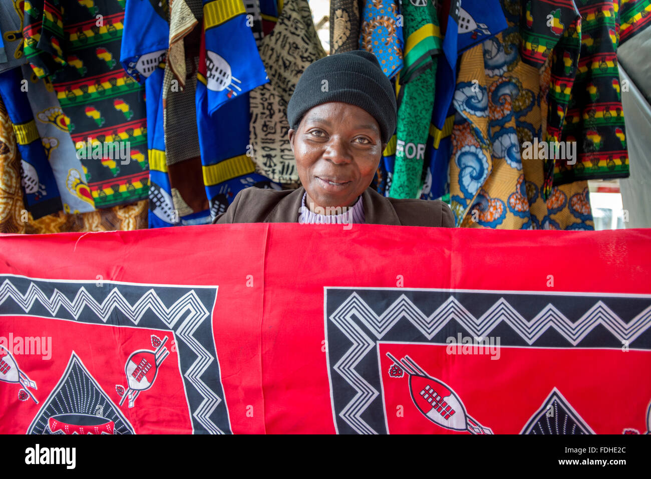African woman selling patterned fabric at the Manzini Wholesale Produce ...