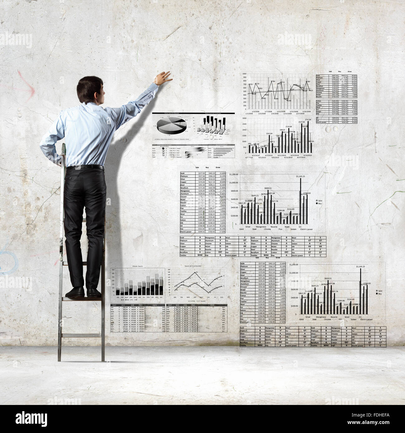 Back view of businessman drawing colorful business ideas on wall Stock ...
