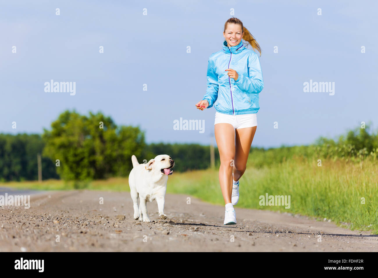Young healthy girl running outdoor with her dog Stock Photo - Alamy