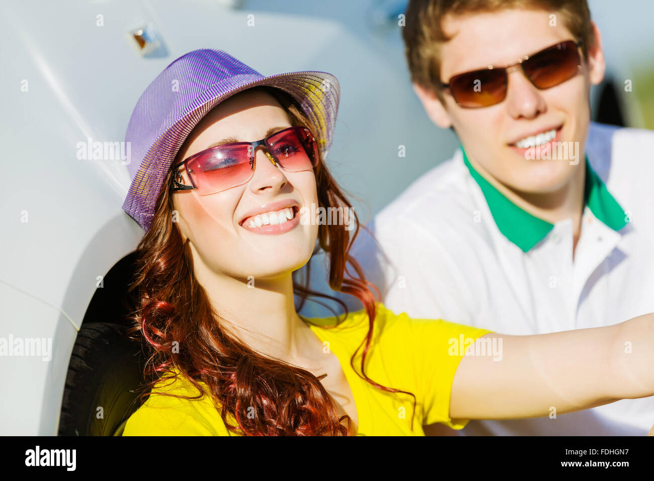 Young people sitting near car aside of road Stock Photo - Alamy