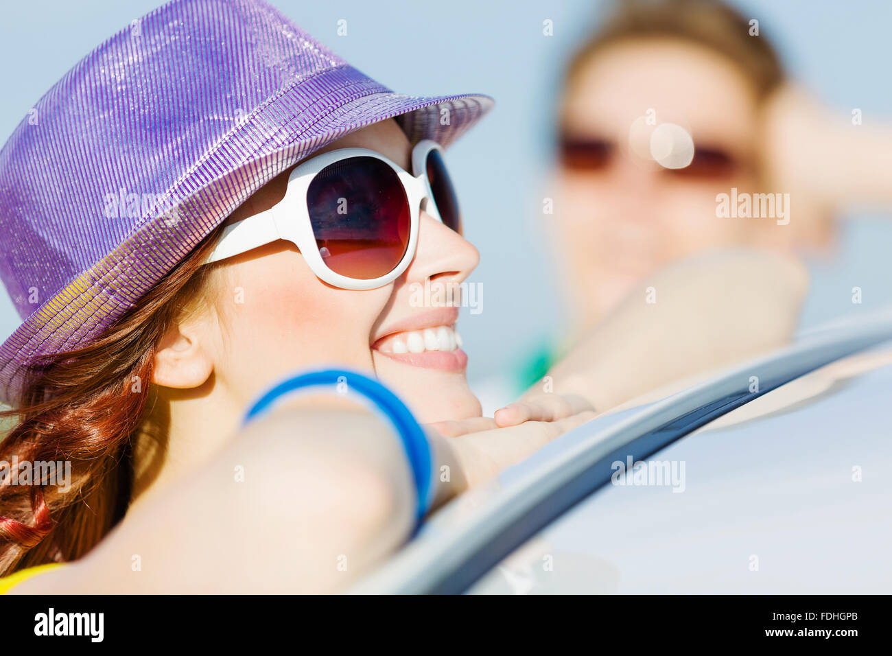 Young people sitting near car aside of road Stock Photo - Alamy