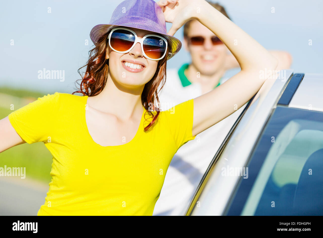 Young people sitting near car aside of road Stock Photo - Alamy