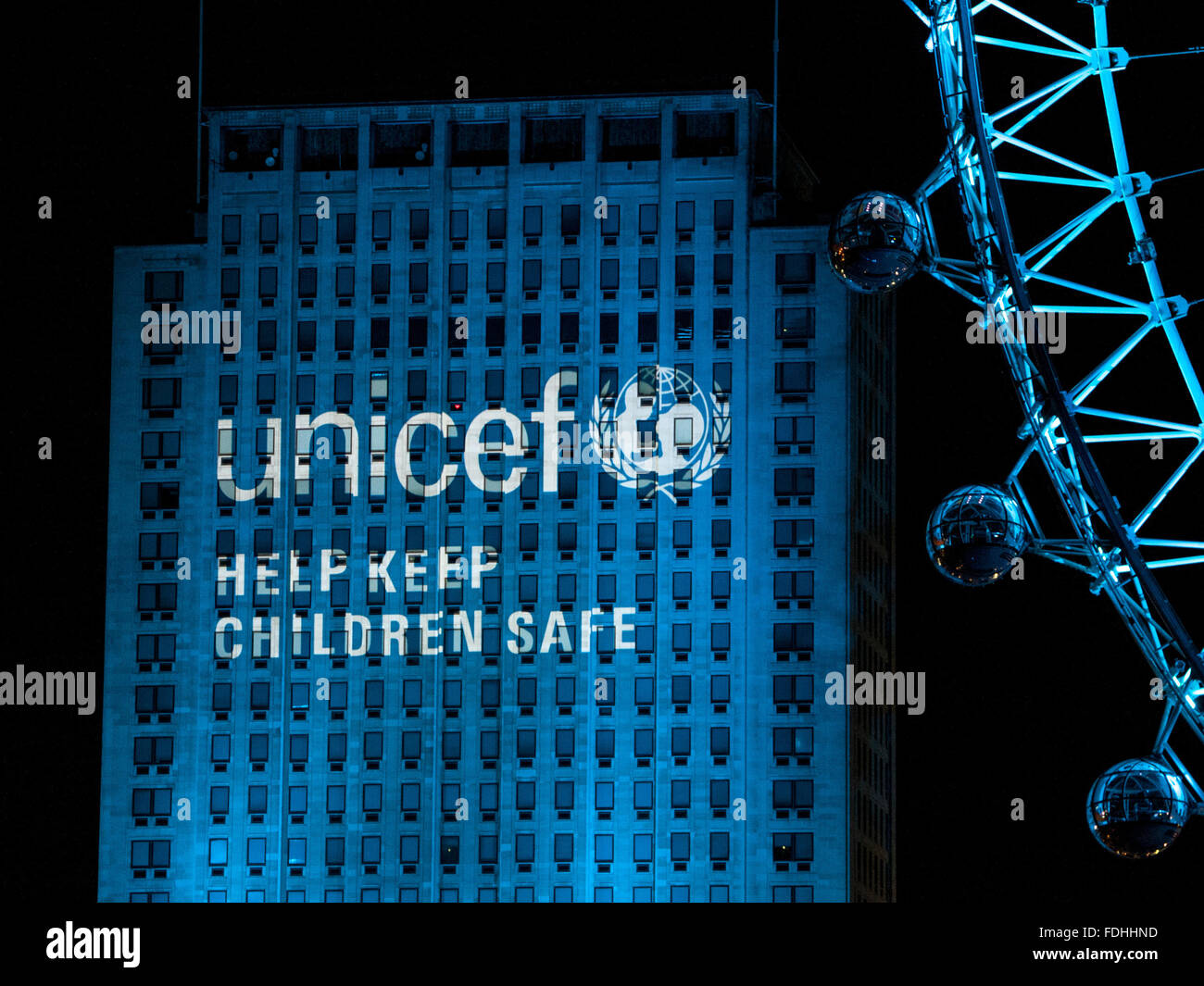 The London Eye and the Shell Building lit up in the Unicef's cyan blue ...