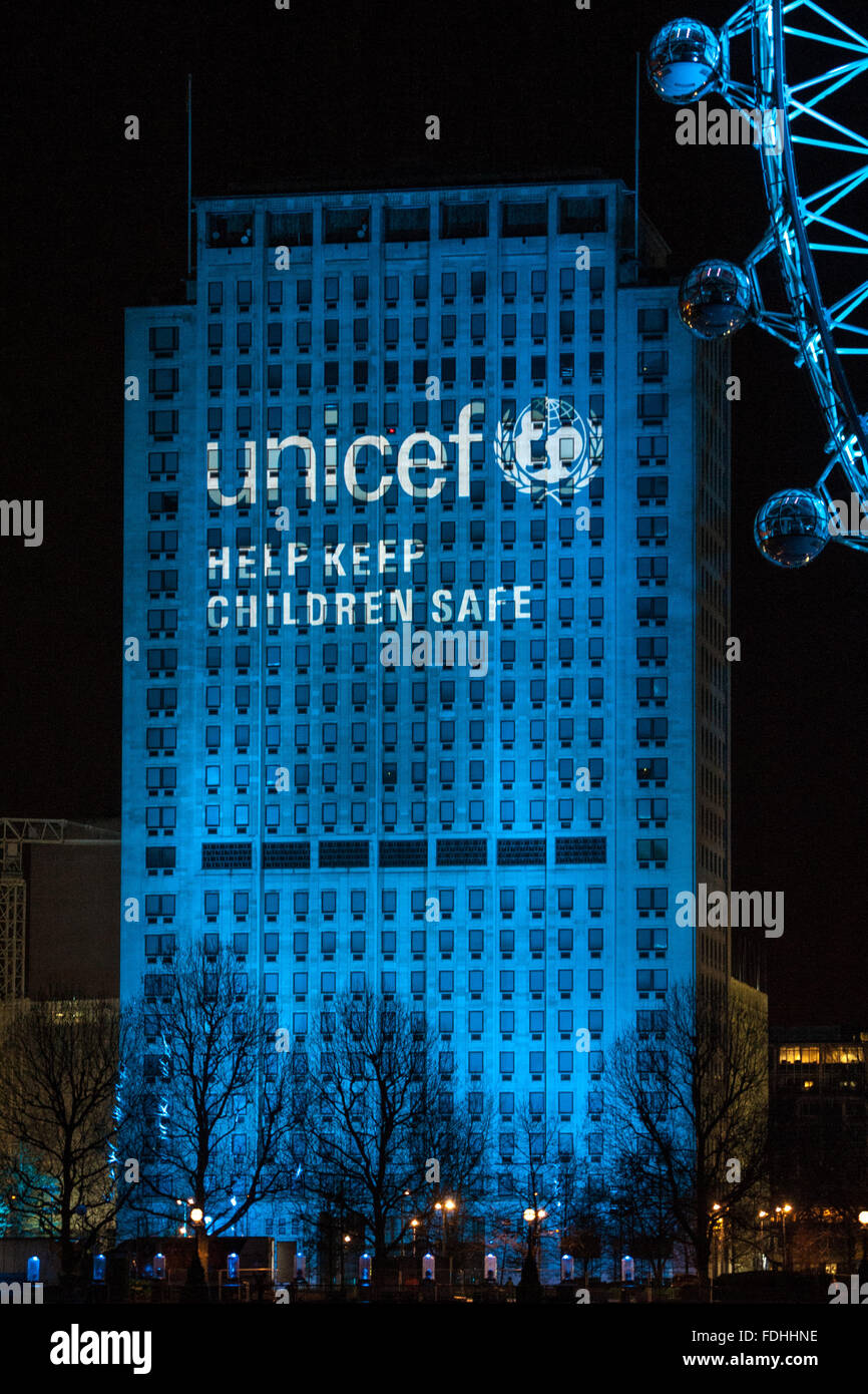 The London Eye and the Shell Building lit up in the Unicef's cyan blue ...
