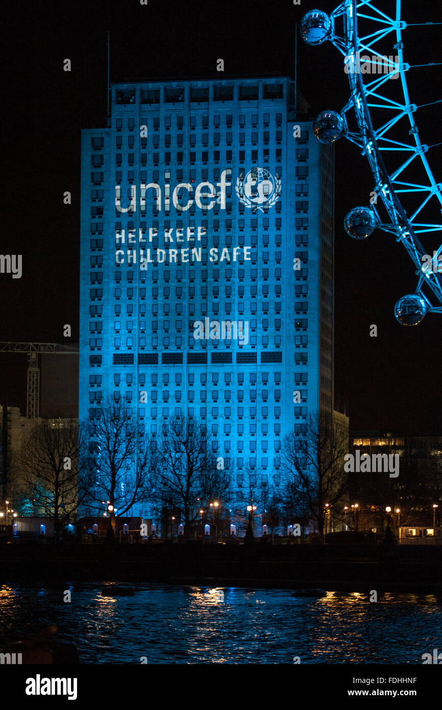 The London Eye and the Shell Building lit up in the Unicef's cyan blue ...