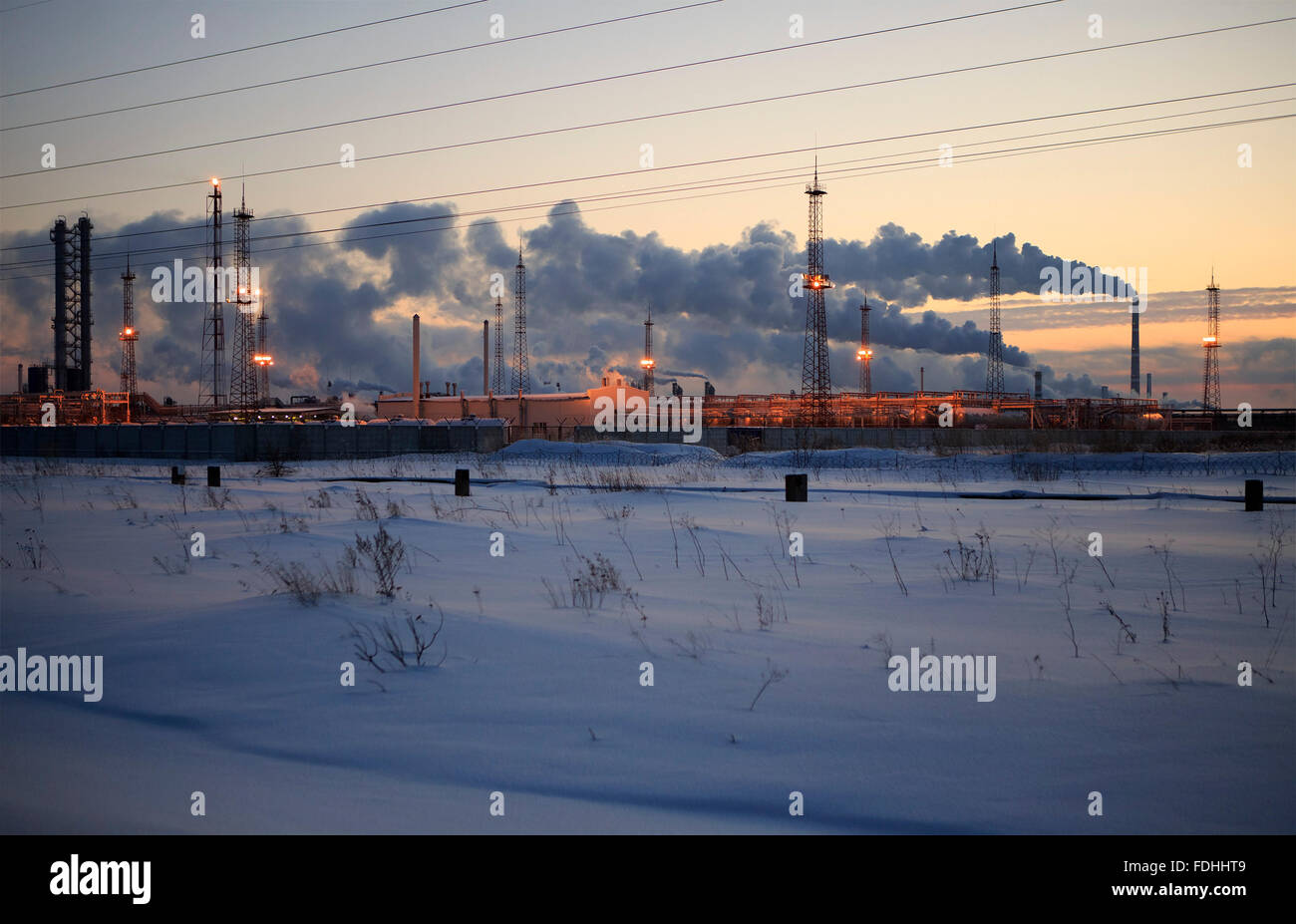Refinery at sunset sky background. Frosty snowy winter evening Stock ...
