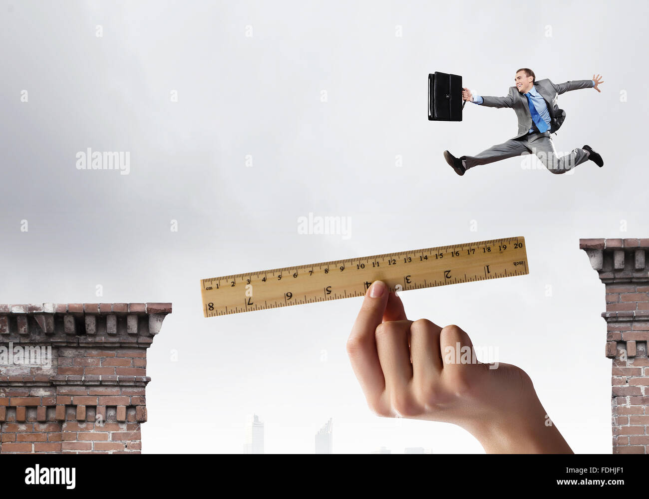 Young successful businessman jumping over gap. Risk and challenge ...