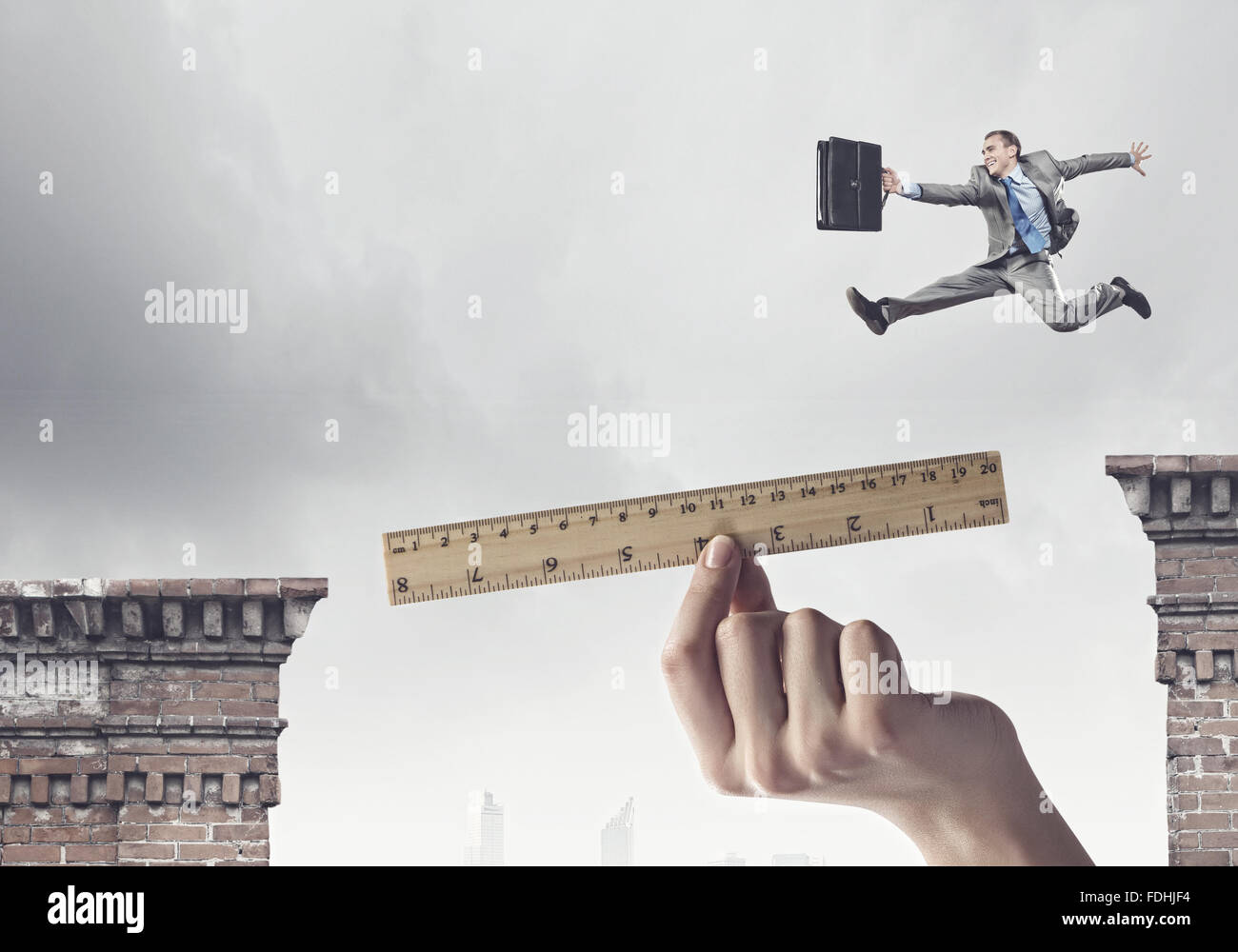 Young successful businessman jumping over gap. Risk and challenge ...