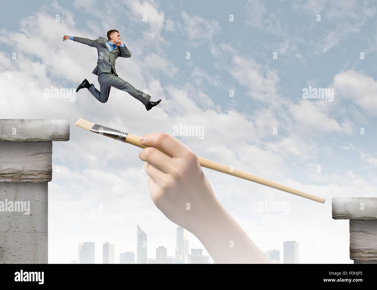 Young successful businessman jumping over gap. Risk and challenge ...