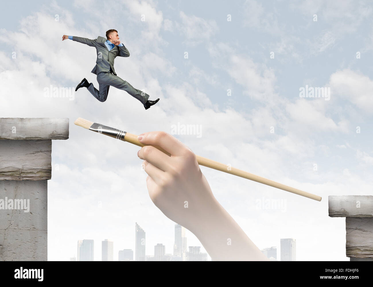Young successful businessman jumping over gap. Risk and challenge ...