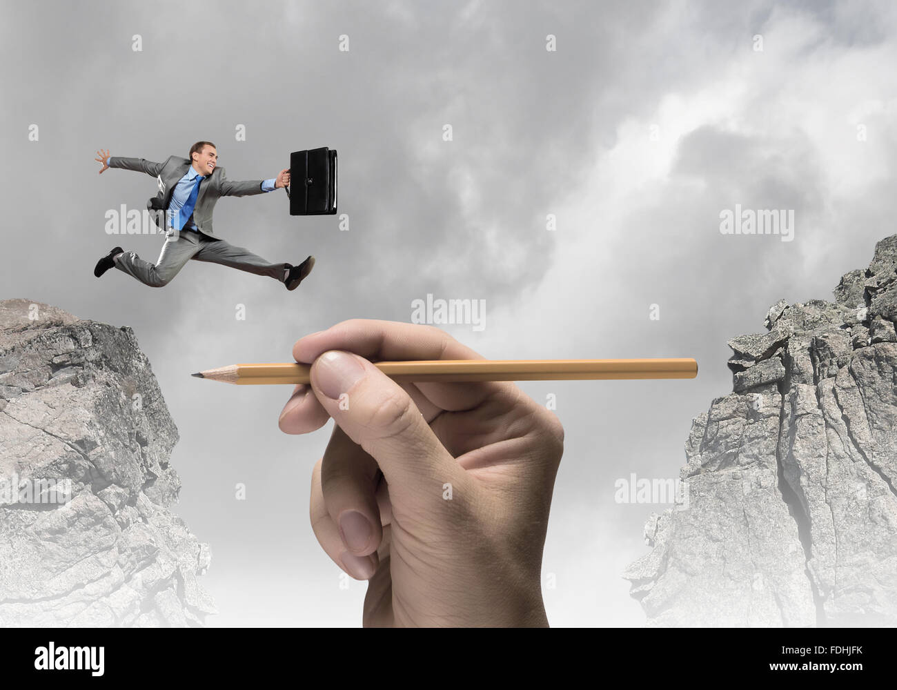 Young successful businessman jumping over gap. Risk and challenge ...