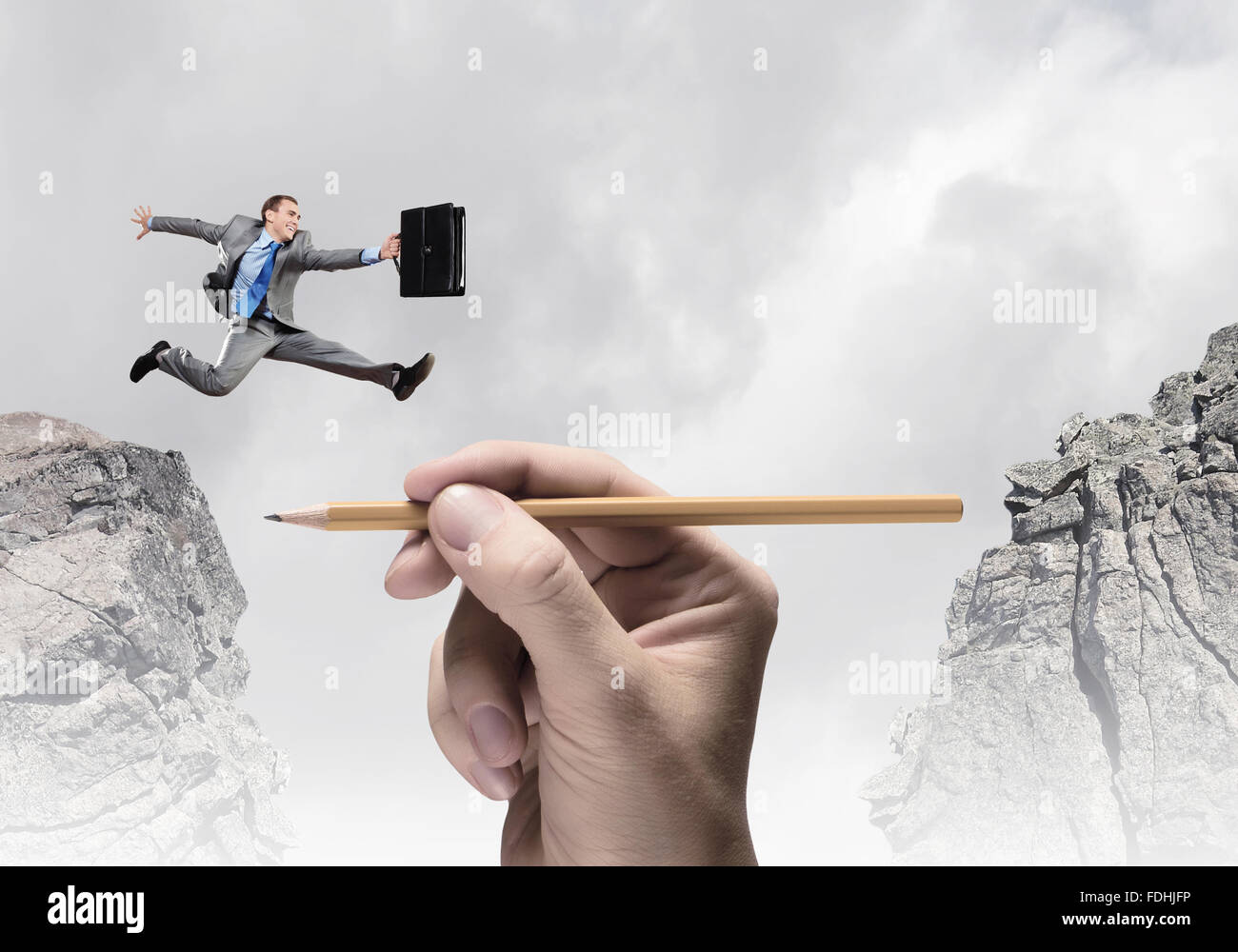 Young successful businessman jumping over gap. Risk and challenge ...