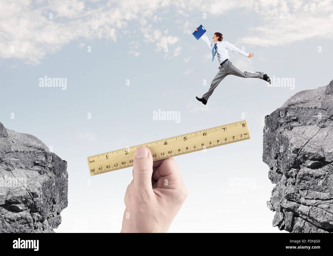 Young successful businessman jumping over gap. Risk and challenge ...