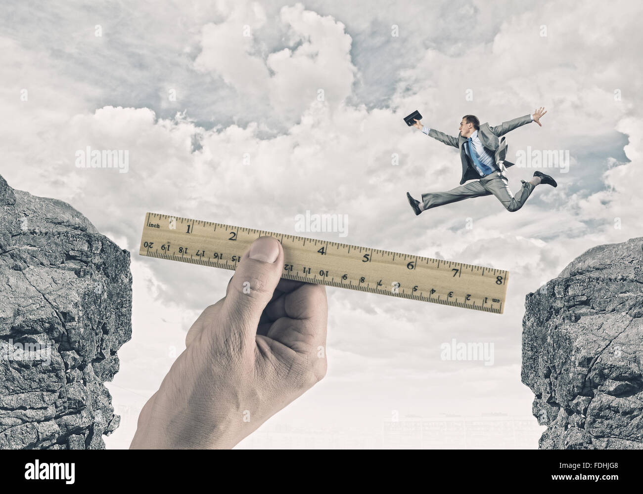 Young successful businessman jumping over gap. Risk and challenge ...