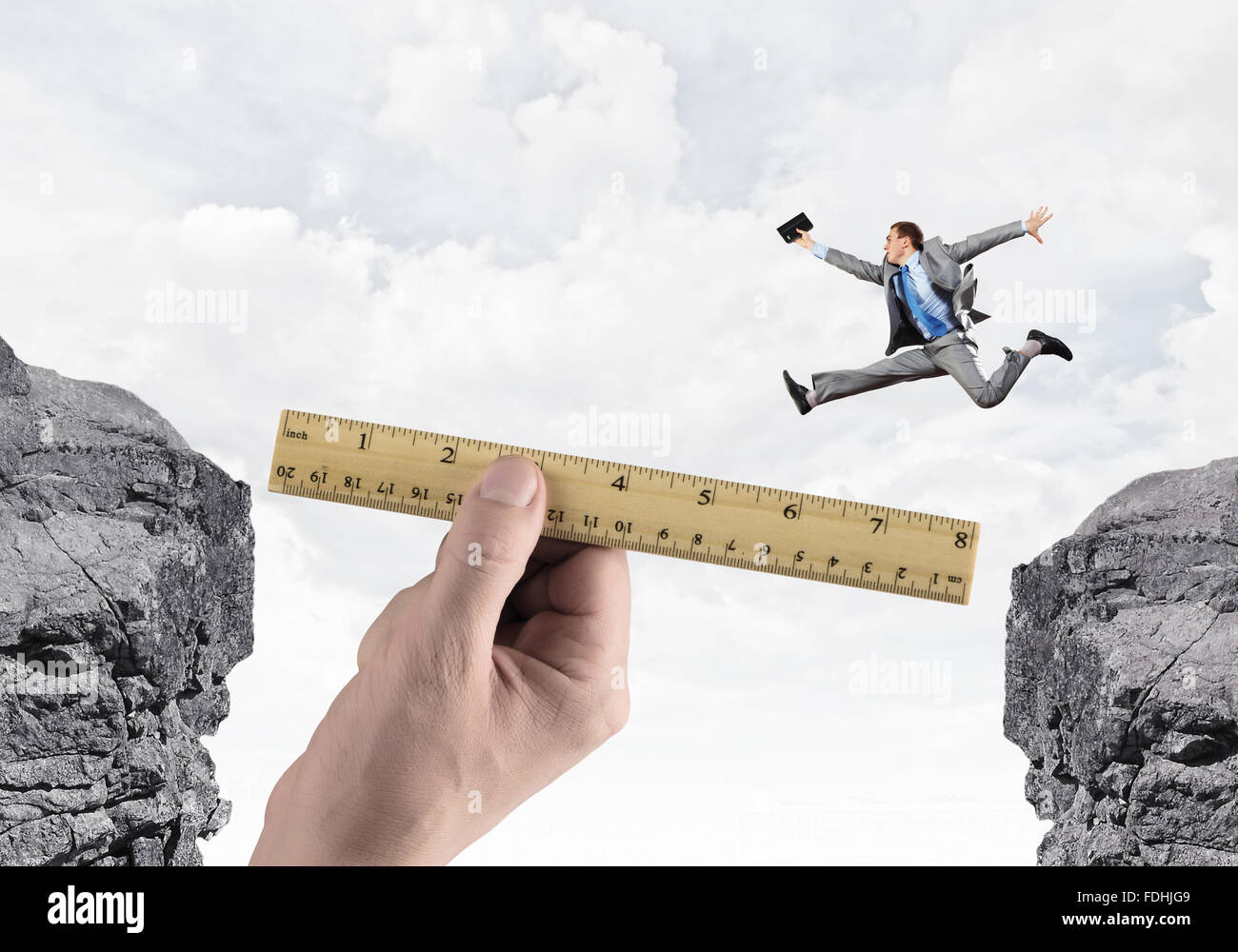 Young successful businessman jumping over gap. Risk and challenge ...