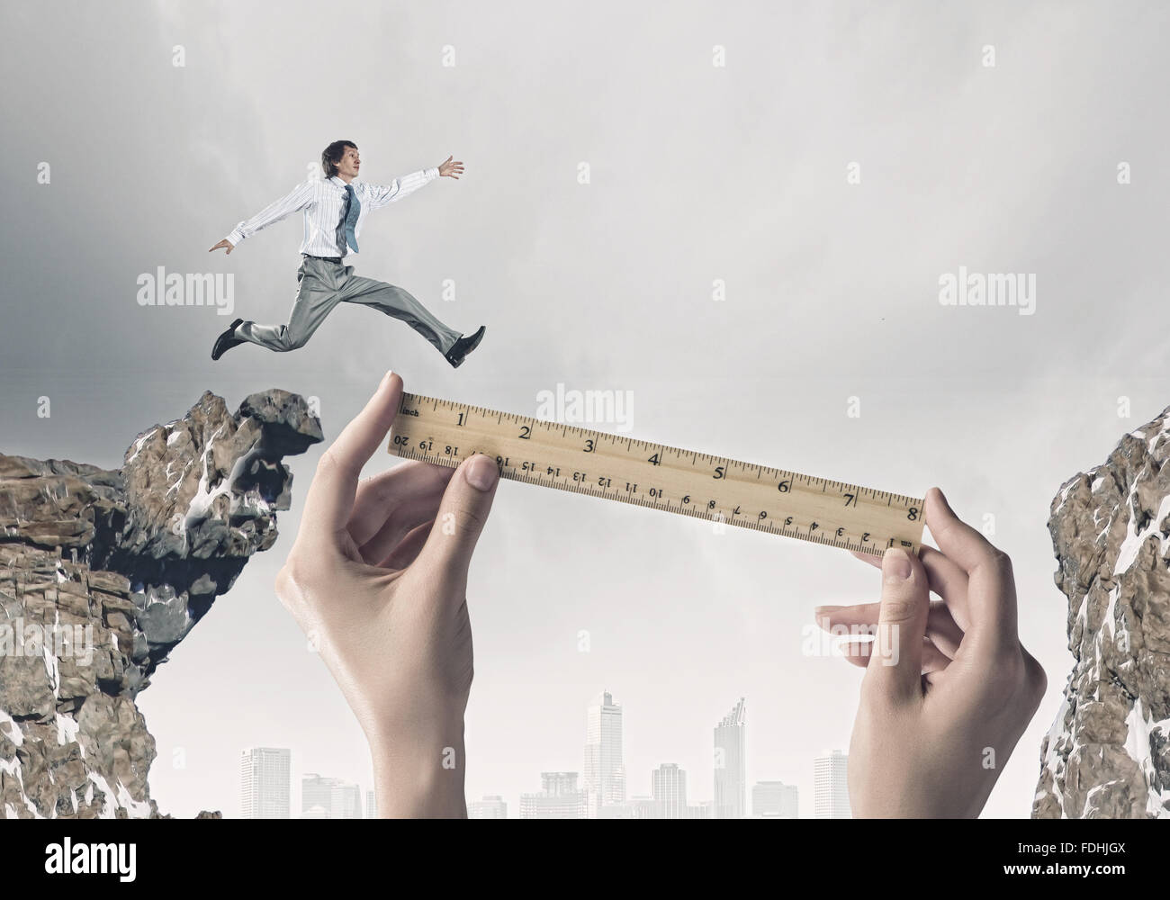 Young successful businessman jumping over gap. Risk and challenge ...