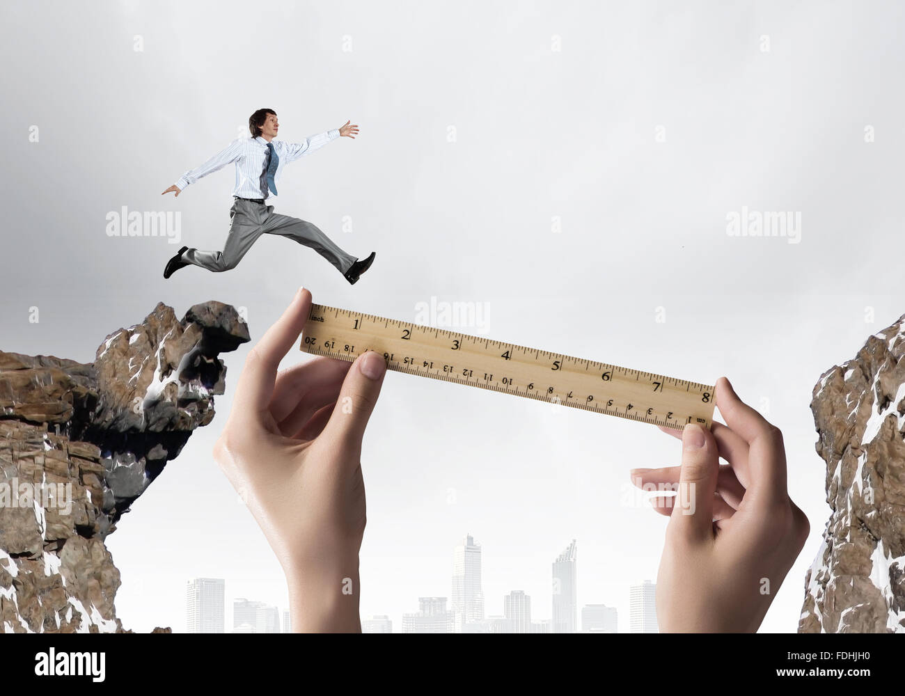 Young successful businessman jumping over gap. Risk and challenge ...