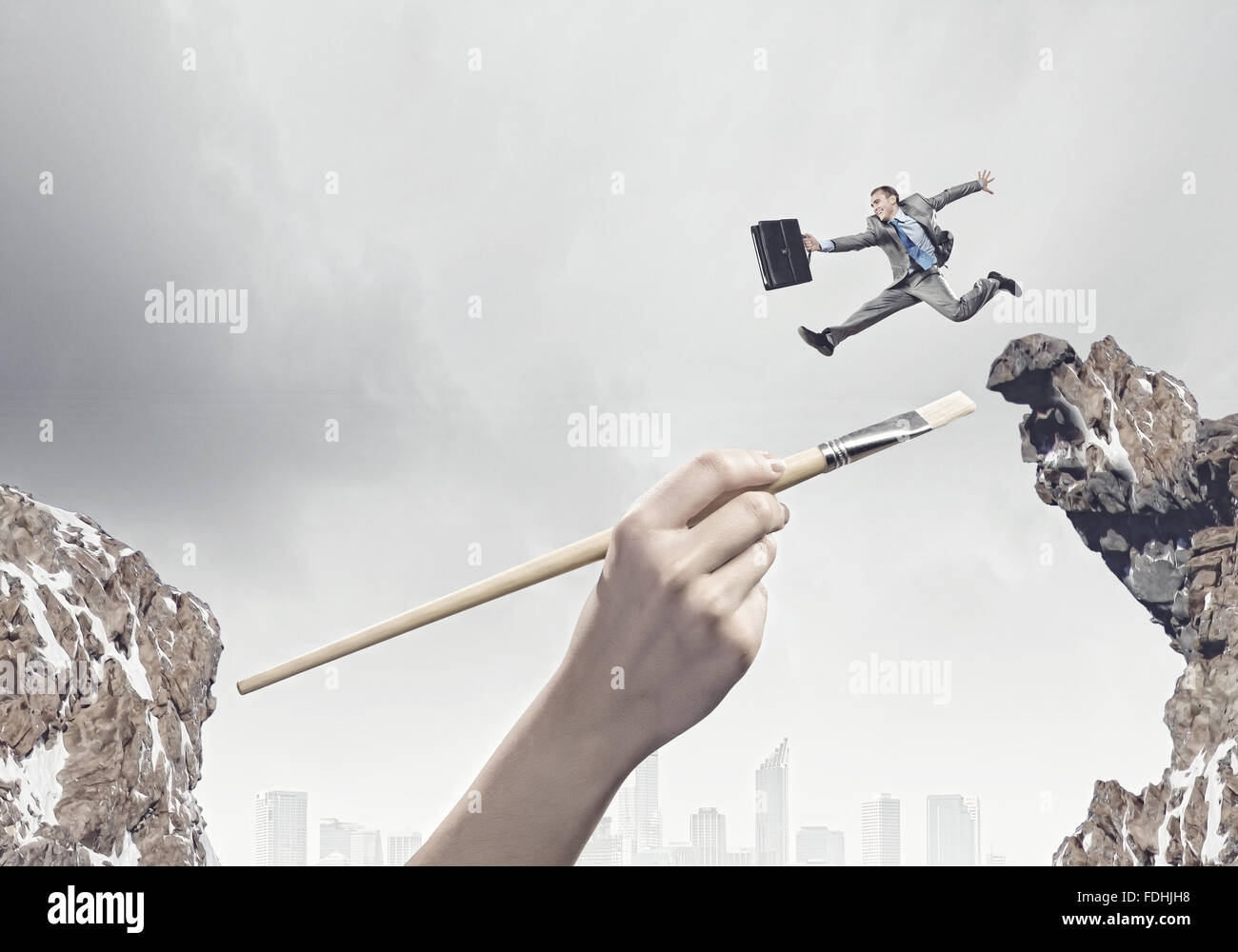 Young successful businessman jumping over gap. Risk and challenge ...