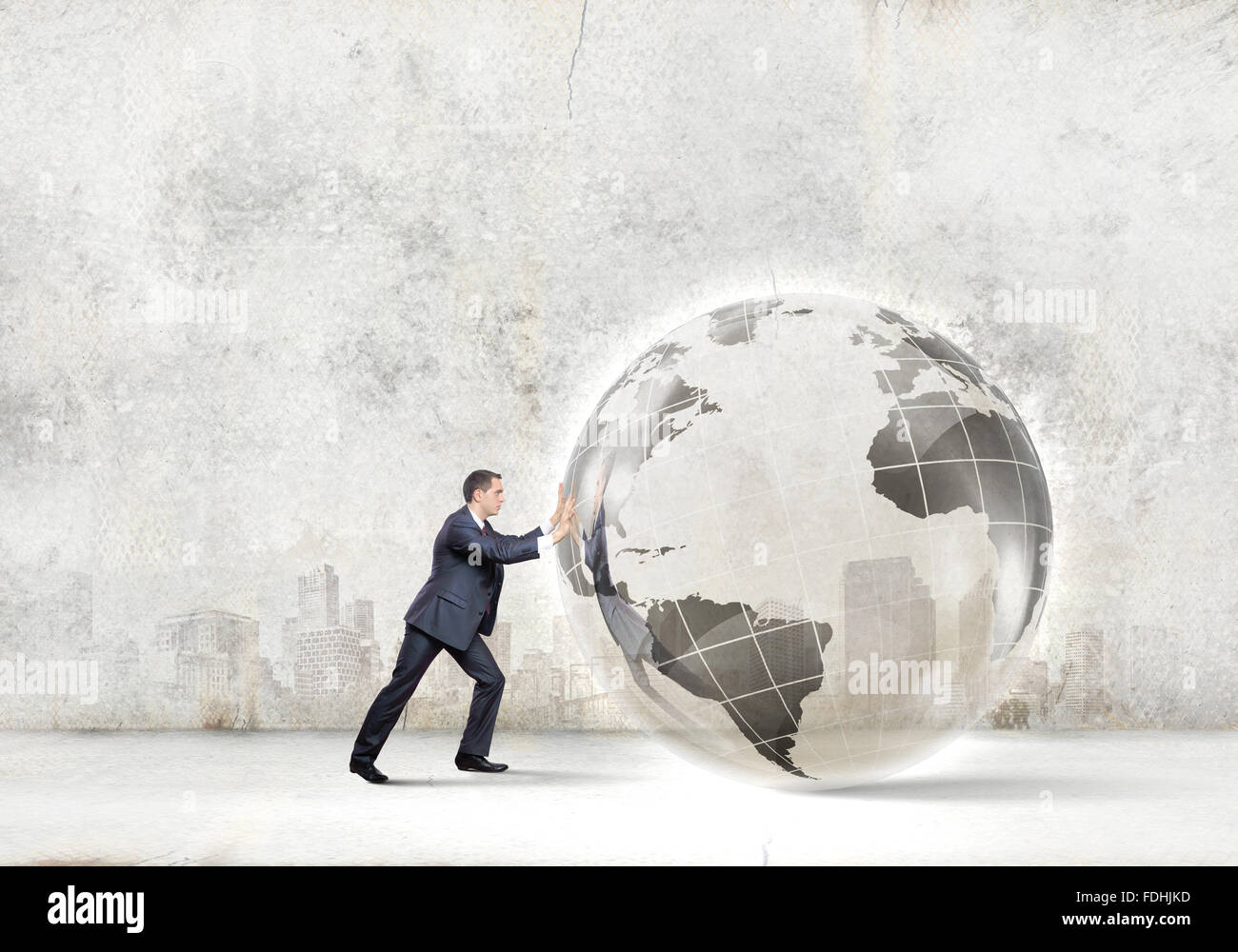 Young successful businessman pushing Earth planet ball Stock Photo - Alamy