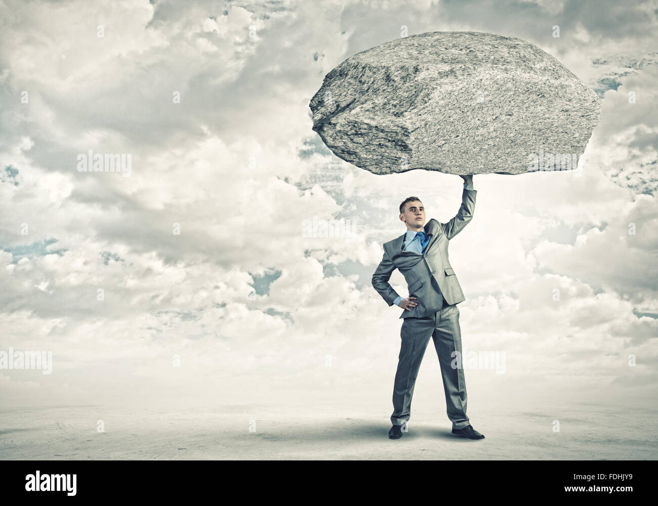 Man holding rock above head hi-res stock photography and images - Alamy
